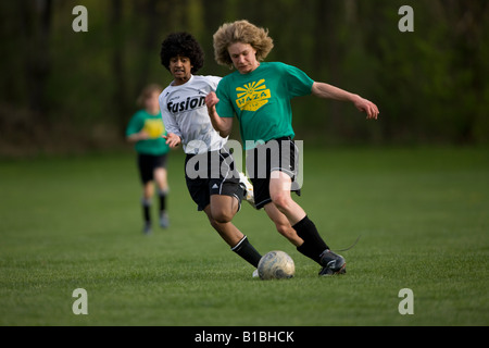 Boys are playing soccer. Boys are running in motion Stock Photo - Alamy