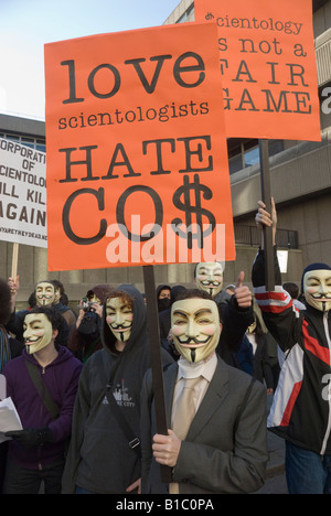 'Anonymous' protest at Church of Scientology, London. Man holds poster ...