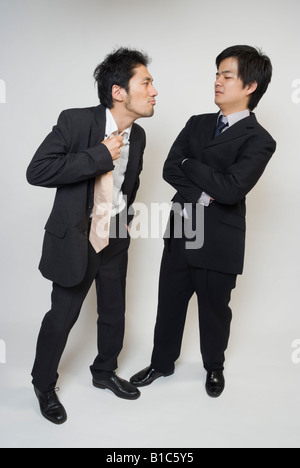 Two young men glaring at each other Stock Photo - Alamy