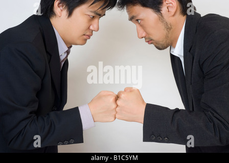 Two businessmen glaring at each other Stock Photo - Alamy