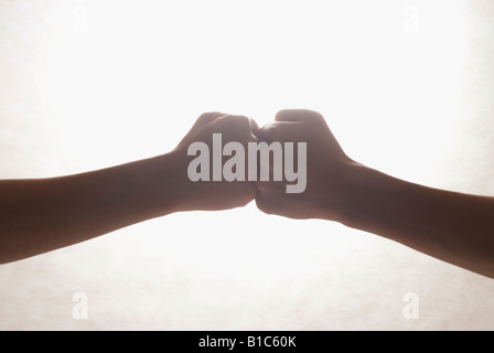 Two hands touching knuckles together Stock Photo - Alamy