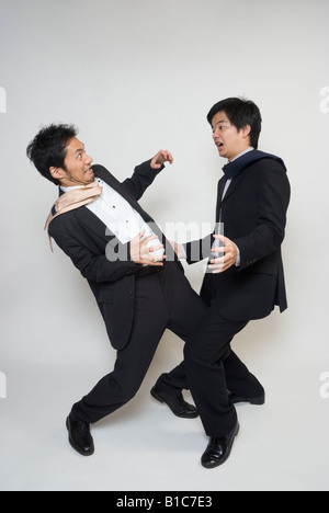 Young Japanese businessmen fighting Stock Photo - Alamy