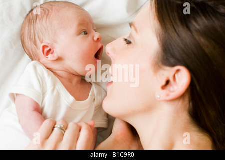 Mother interacting with her newborn baby Stock Photo - Alamy