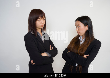 Two young businesswomen confronting Stock Photo - Alamy