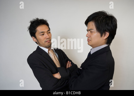 Two young men glaring at each other Stock Photo - Alamy