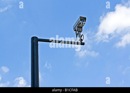 CCTV camera on high angular mast framed by buildings Stock Photo - Alamy