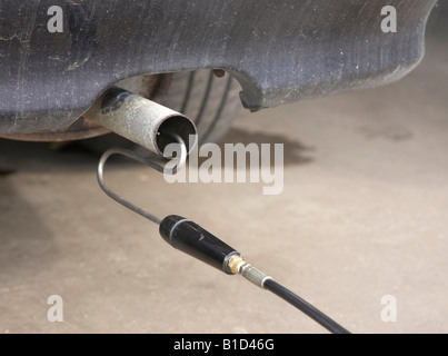 exhaust emissions test equipment being used during an MOT check for a ...