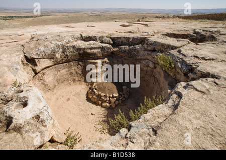 View of holes and pit in bedrock at The Neolithic site of Gobekli Tepe ...