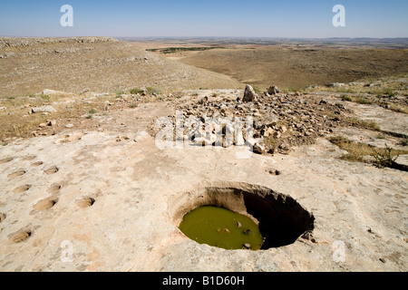 View of holes and pit in bedrock at The Neolithic site of Gobekli Tepe ...