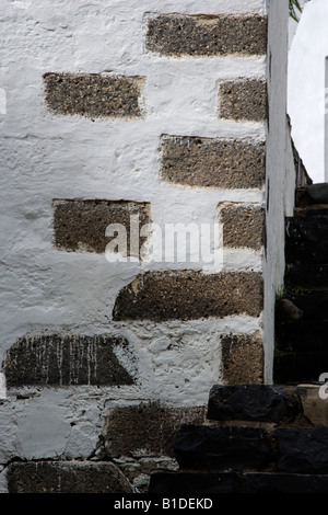 A close-up of a decorative dynamic wall made of rectangular stone ...