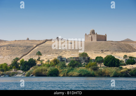 An islamic mosque on a hill across the Nile river from Aswan Egypt ...
