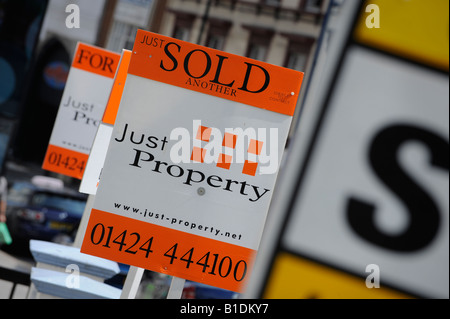 lots of estate agent boards for sale, sold, to let boards all lined up ...