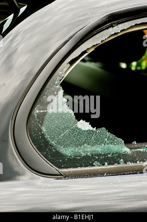 Smashed rear quarter window of black Jaguar car parked on a York street ...