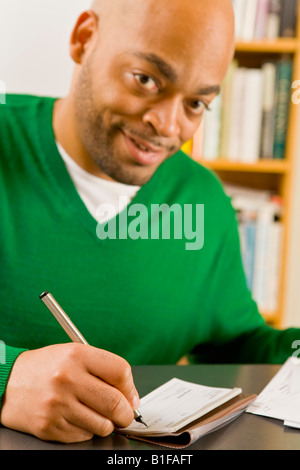 Writing a check Stock Photo - Alamy