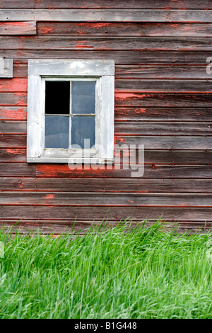 Broken window on a red barn Stock Photo - Alamy
