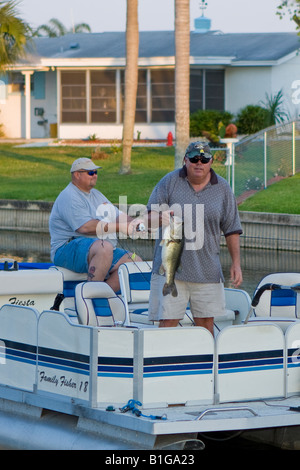 Bass fishing. Fisherman and trophy trout. River grayling on the hook ...