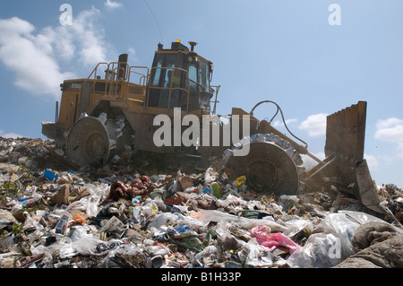 Digger working at landfill site Stock Photo - Alamy