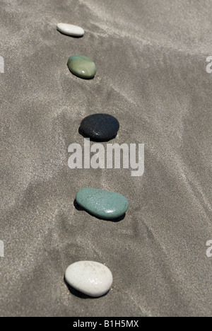 Pebbles in sand Stock Photo - Alamy