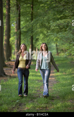 Two women friends walking and talking in a modern shopping mall Stock ...