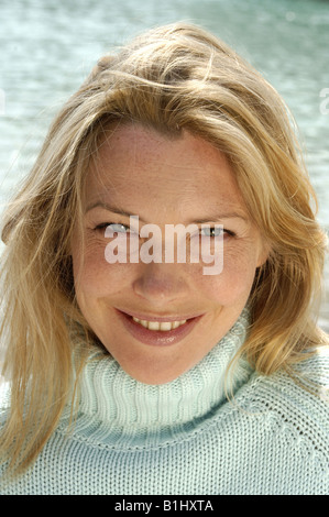 Woman in turquoise pullover at the sea Stock Photo - Alamy