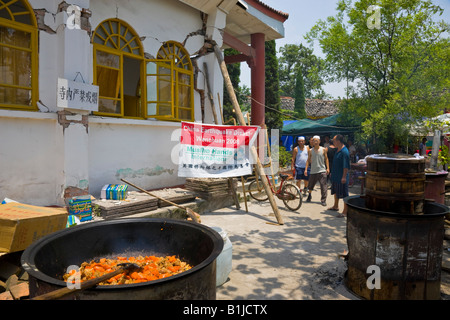 Food cooking outside earthquake severely damaged mosque in Luoshui ...