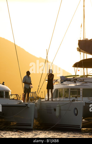 couple on deck of moored catamaran in the evening Stock Photo - Alamy