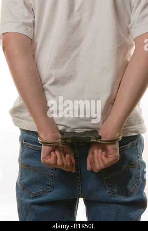 Hands cuffed behind back Stock Photo - Alamy