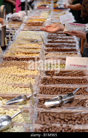 A man selling sweets on a stall in the back streets of a Jaipur bazaar ...