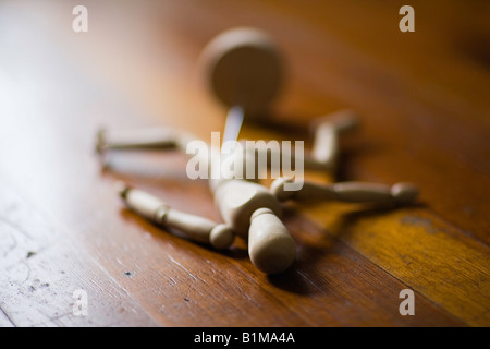 A Fallen Drawing Figurine on Wood Floor Stock Photo - Alamy