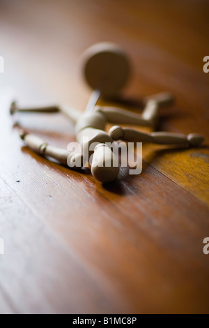 A Fallen Drawing Figurine on Wood Floor Stock Photo - Alamy