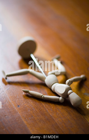 A Fallen Drawing Figurine on Wood Floor Stock Photo - Alamy