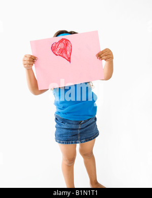 Little girl showing off drawing at home Stock Photo - Alamy
