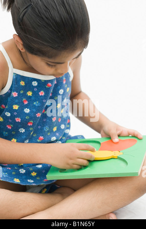 Close up of an Indian girl playing with toys Stock Photo - Alamy