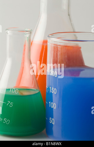 Laboratory conical flasks and beaker with colored liquid reagents ...
