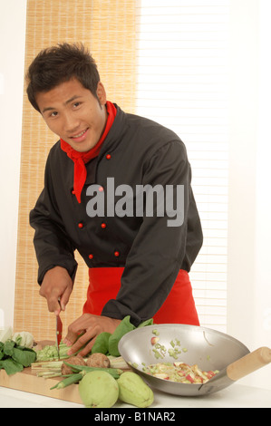 Asian cook with a peking pan Stock Photo - Alamy