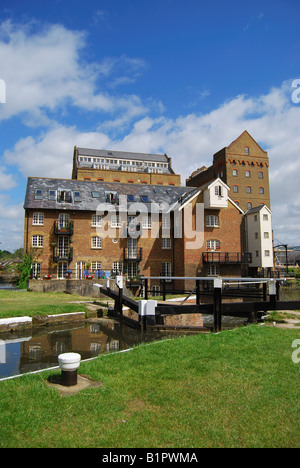 Coxes Lock Mill apartments on the River Wey Navigation canal on a sunny ...