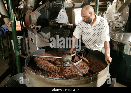 A man at a roastery is roasting coffee, Goroka, Papua New Guinea ...
