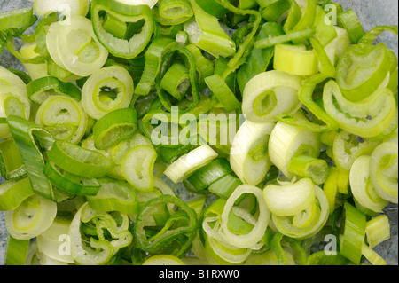 Close-up of Chopped green spring onions and edible mushrooms in a ...