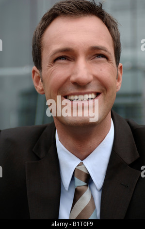 31-year-old businessman wearing a suit, holding newspaper Stock Photo ...