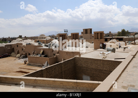 View of the city with traditional wind catchers and mosques at dusk ...