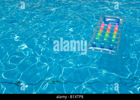 Rubber Lilo floating in a swimming pool Stock Photo - Alamy
