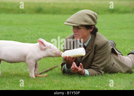 Shepherdess Katy Cropper bottle feeding piglet. farmer farming female ...