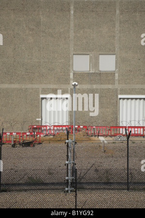 Security fence of a nuclear power station with yellow danger warning ...