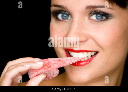 woman biting strawberry string sweet Stock Photo - Alamy