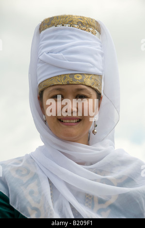 A Kazakh woman wearing a traditional saukele bridal headdress and a ...