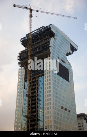 construction crane being built using a secondary crane shot against ...