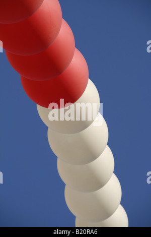 long line of red white balloons in blue sky Stock Photo - Alamy