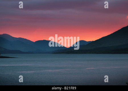 red sunset over mountains and a lake in australia reflecting Stock ...
