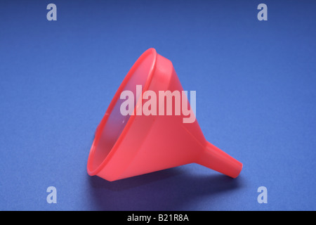 red colored cone shaped funnel used for pouring liquid into small hole ...