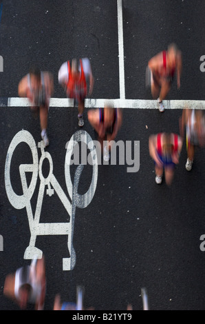 Athletes running in the London marathon event on a paved city road ...